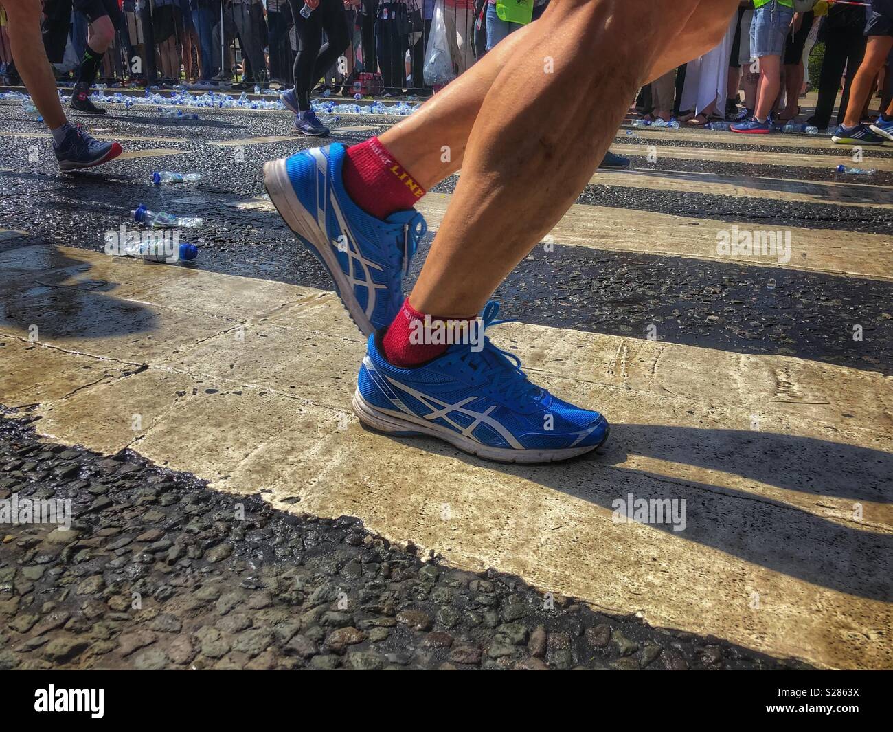 Marathon runners feet and trainers over a zebra crossing Stock Photo ...