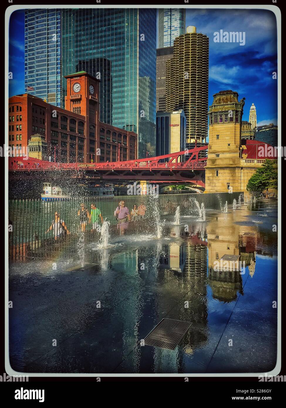 Chicago riverwalk used for recreation and commuting. Commuters walk by ...