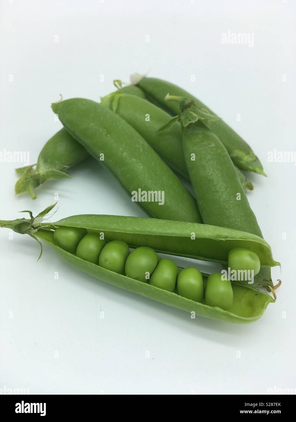 Peas in a pea pod Stock Photo - Alamy
