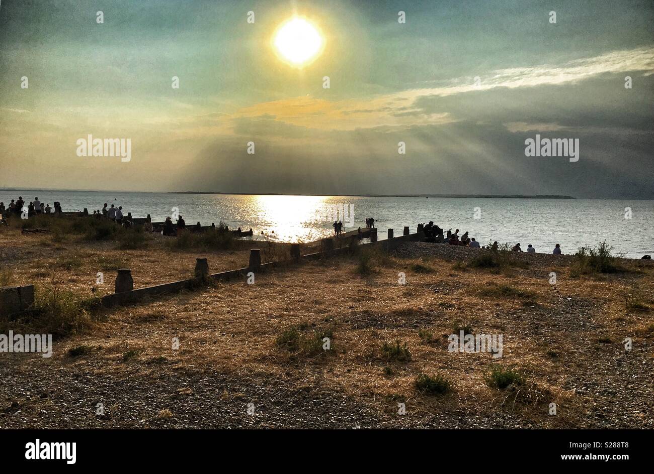 Beach sunset with clouds hi-res stock photography and images - Alamy