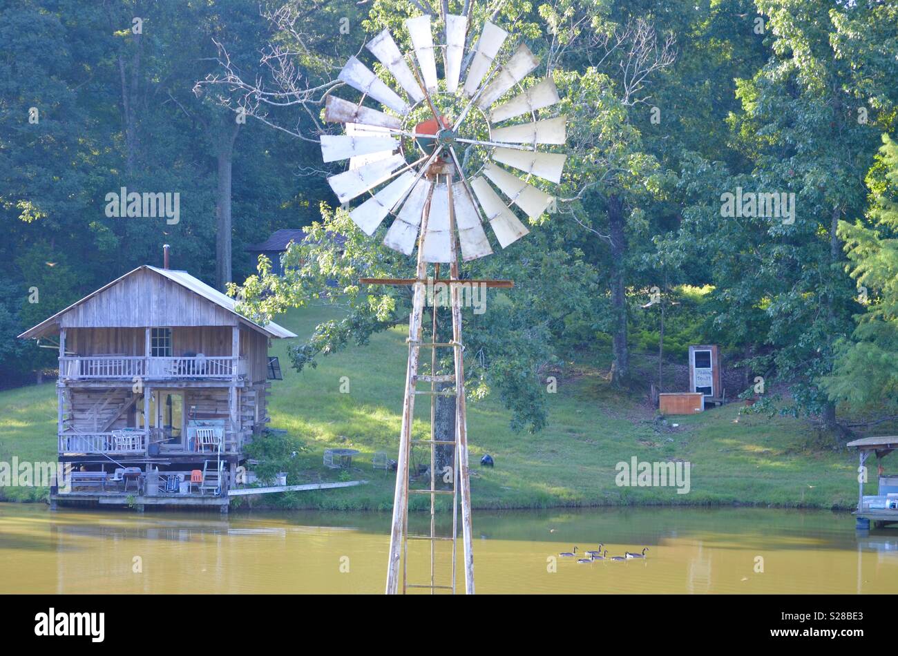 Windmill by a cabin Stock Photo - Alamy