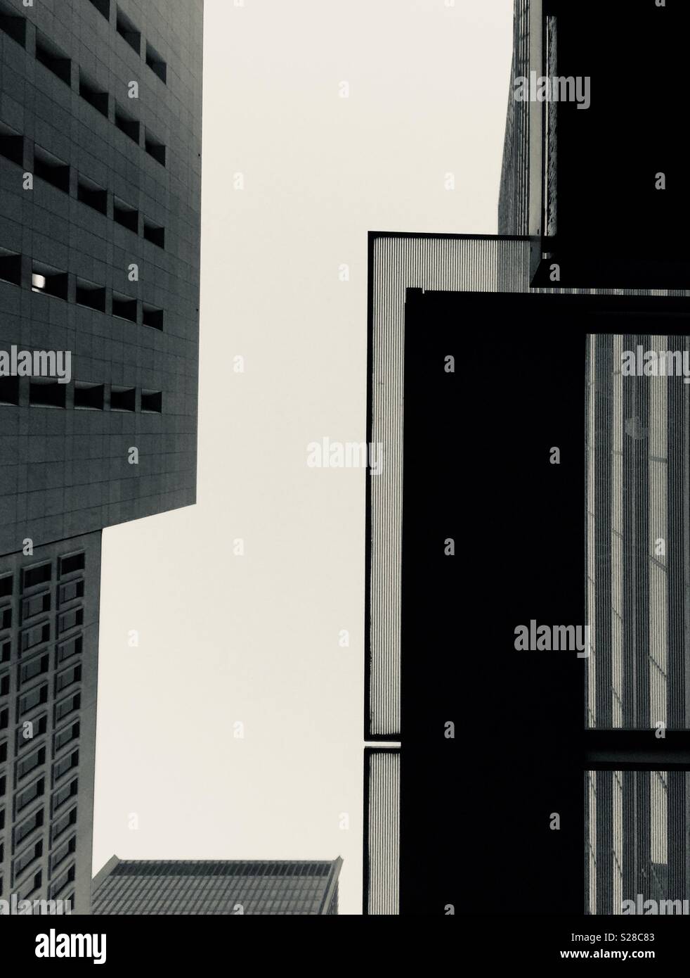Looking up at office building with one light on Stock Photo - Alamy