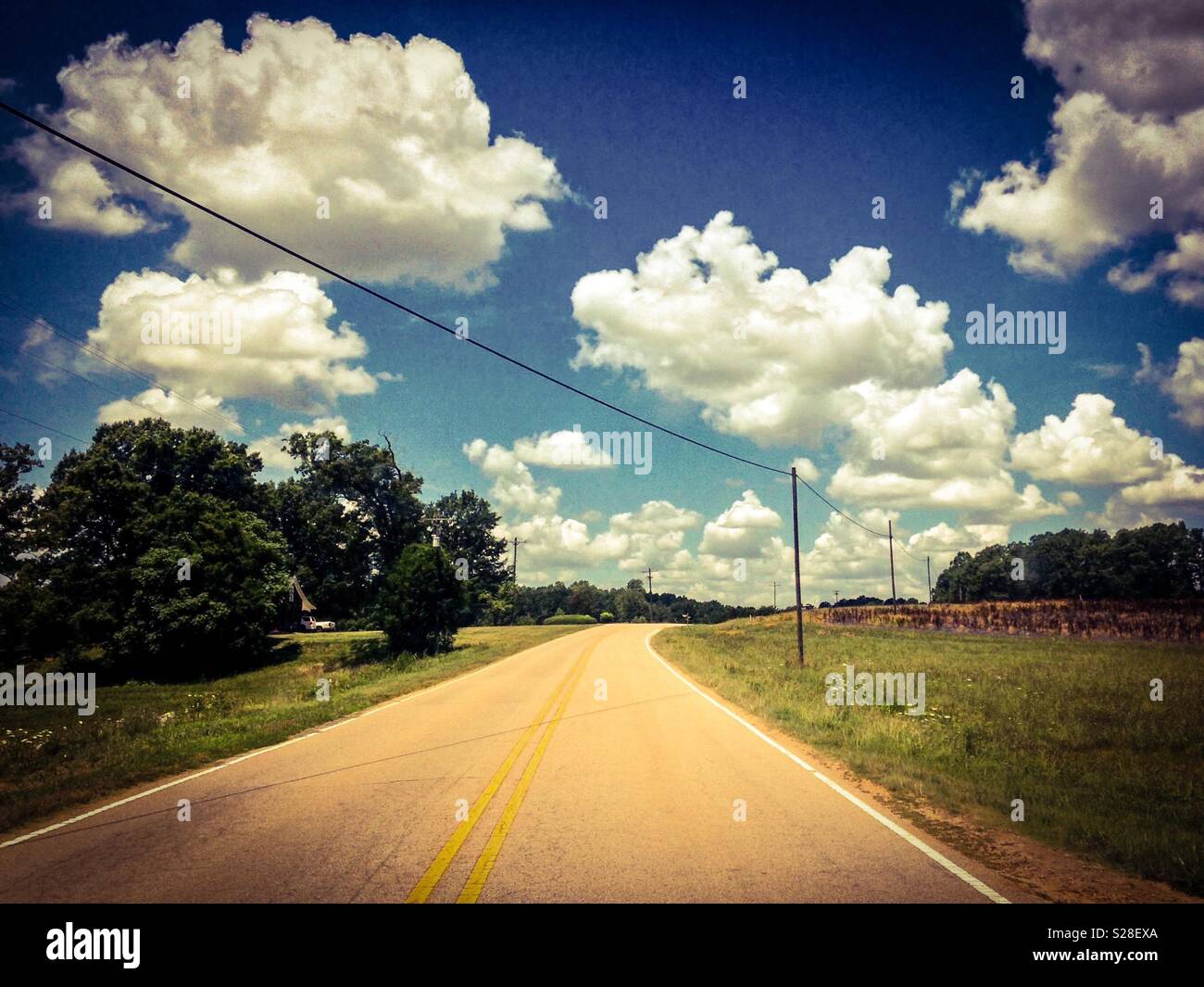 Fluffy white cumulus clouds in summer sky over rural North Carolina ...