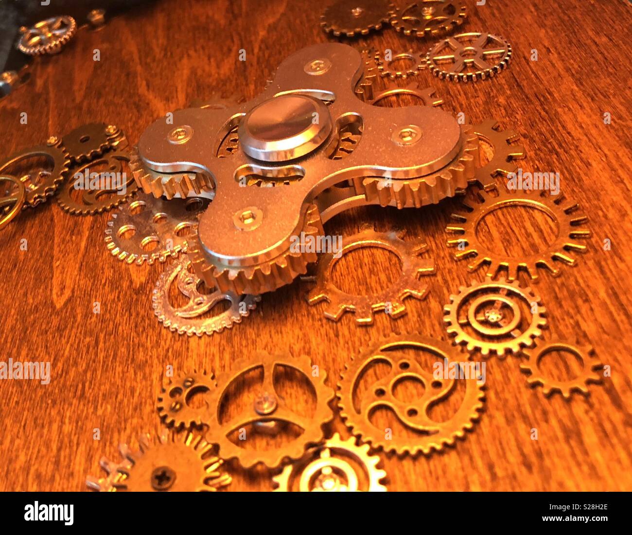 Steampunk silver and gold metal gears and cogs on wood Stock Photo - Alamy
