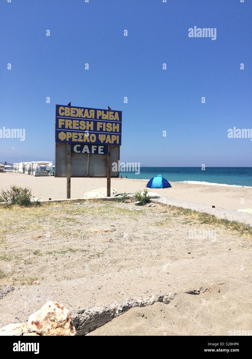 Greek fish sign on Cretan beach Stock Photo - Alamy