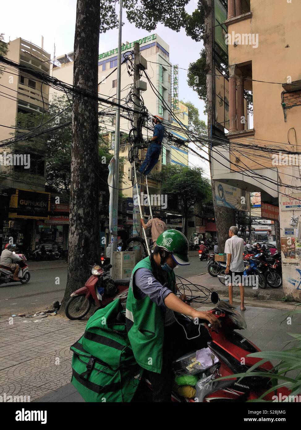 A grab operator in saigon's busy streets Stock Photo - Alamy
