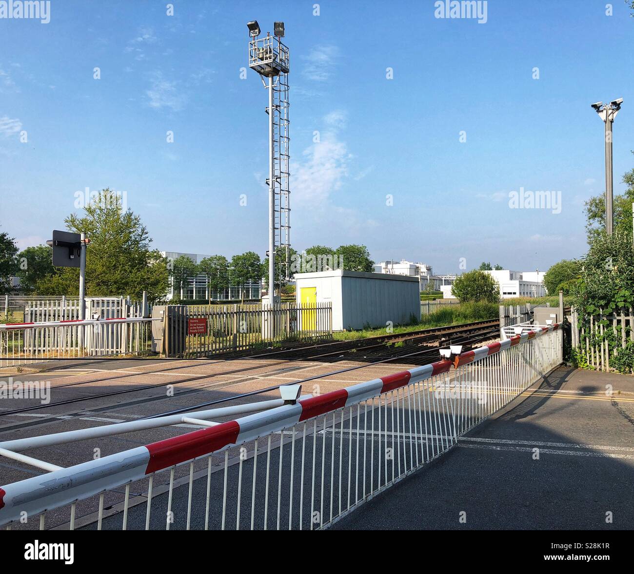 Level crossing on the Merseyrail Wirral Line with barriers down at ...