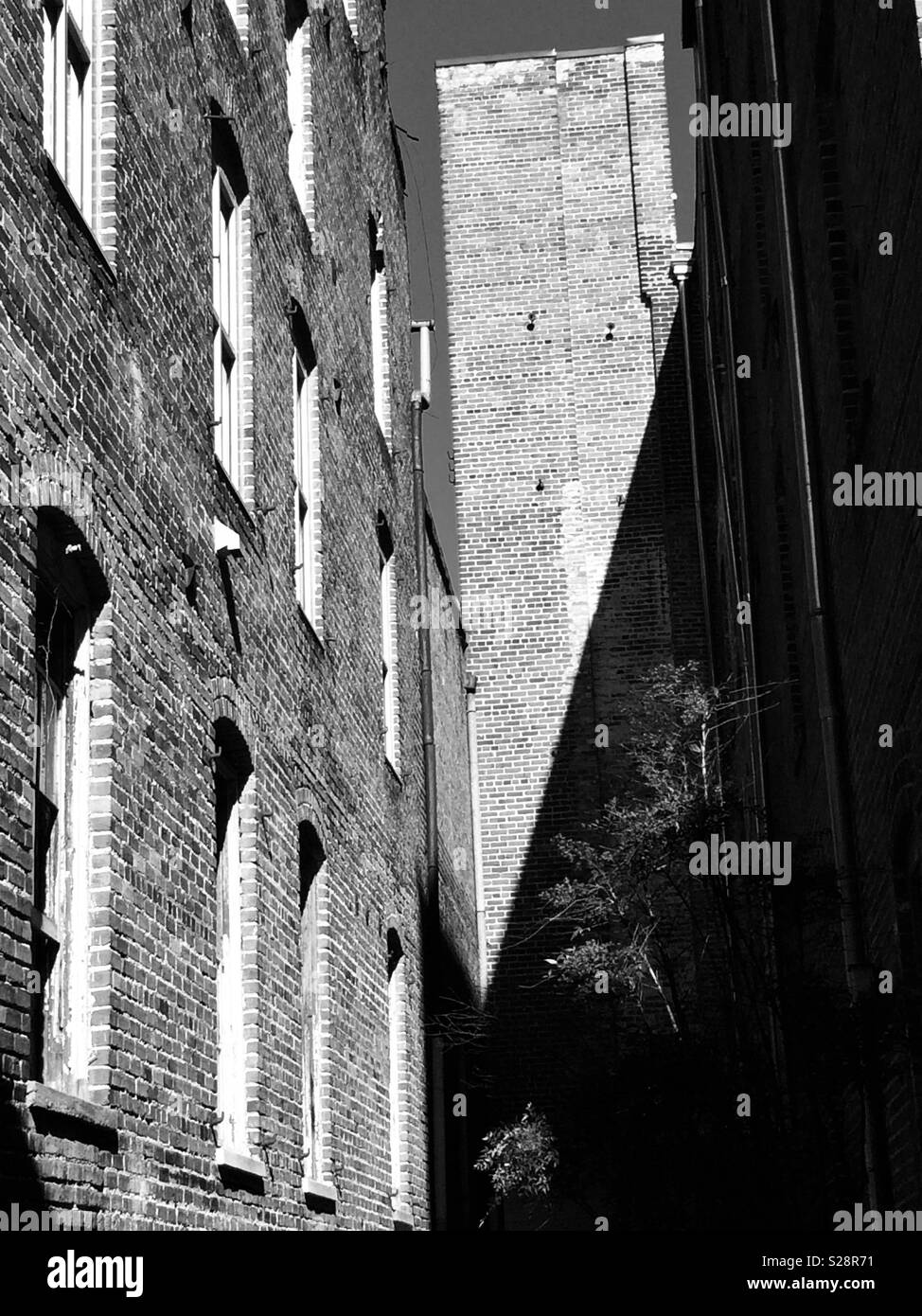 Graphic shadows on brick buildings in black and white Stock Photo - Alamy