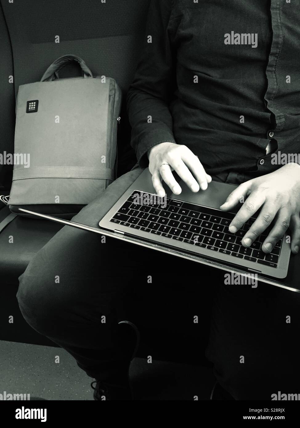 Typing at Train Stock Photo - Alamy