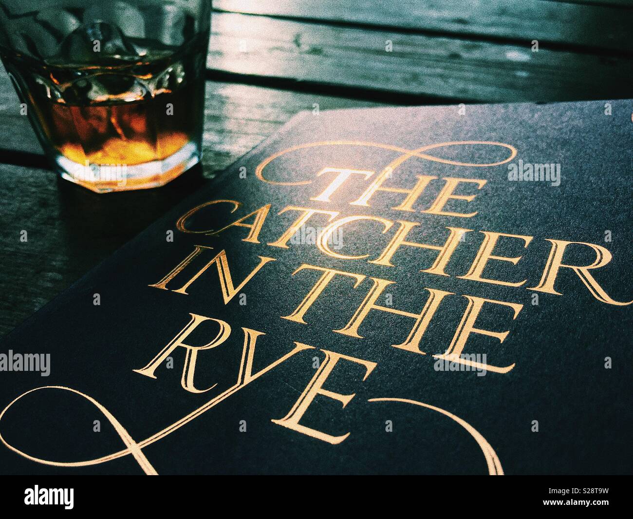 Reading with a drink Stock Photo - Alamy