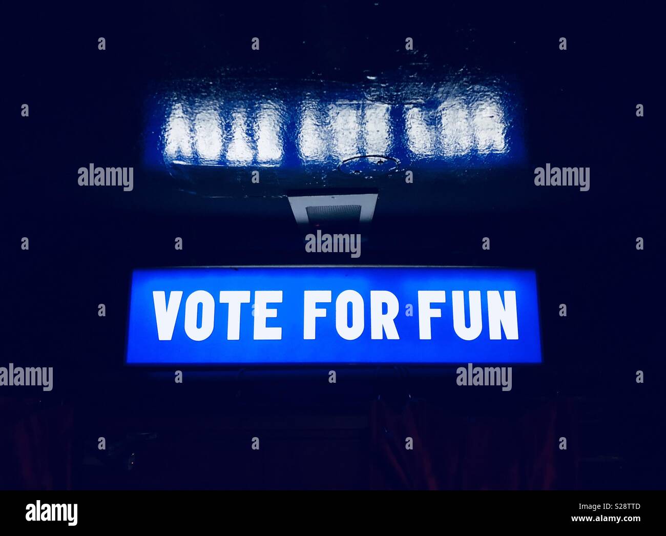 Vote for fun illuminated sign Stock Photo - Alamy