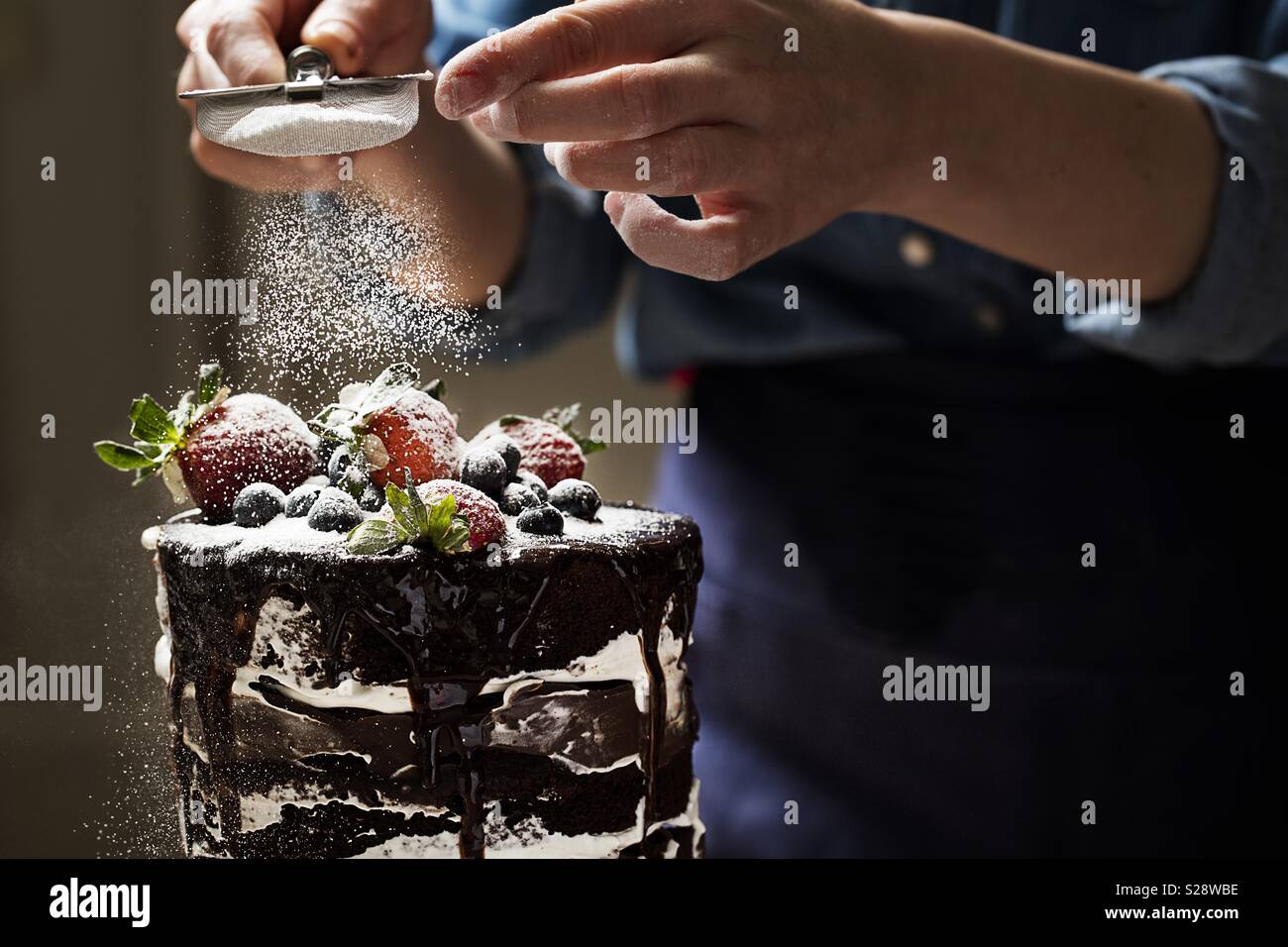 chef is making last touchs to cake Stock Photo - Alamy