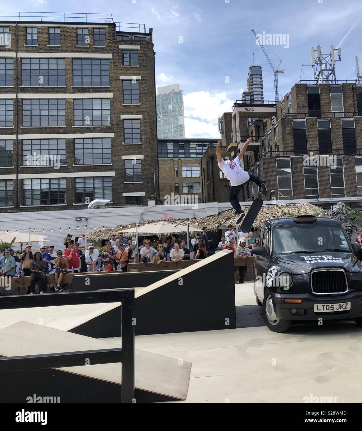 Man jumping over taxi on skateboard Stock Photo - Alamy