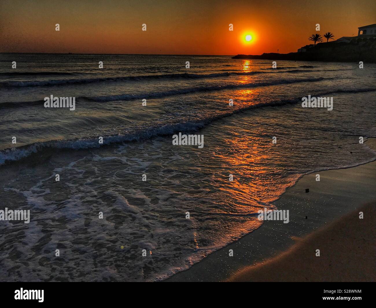 Sunrise over sea and beach Stock Photo - Alamy