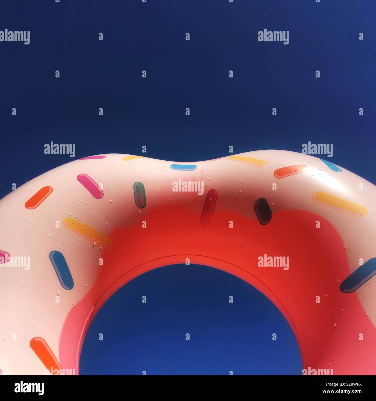 Inflatable doughnut float against vivid blue sky Stock Photo - Alamy
