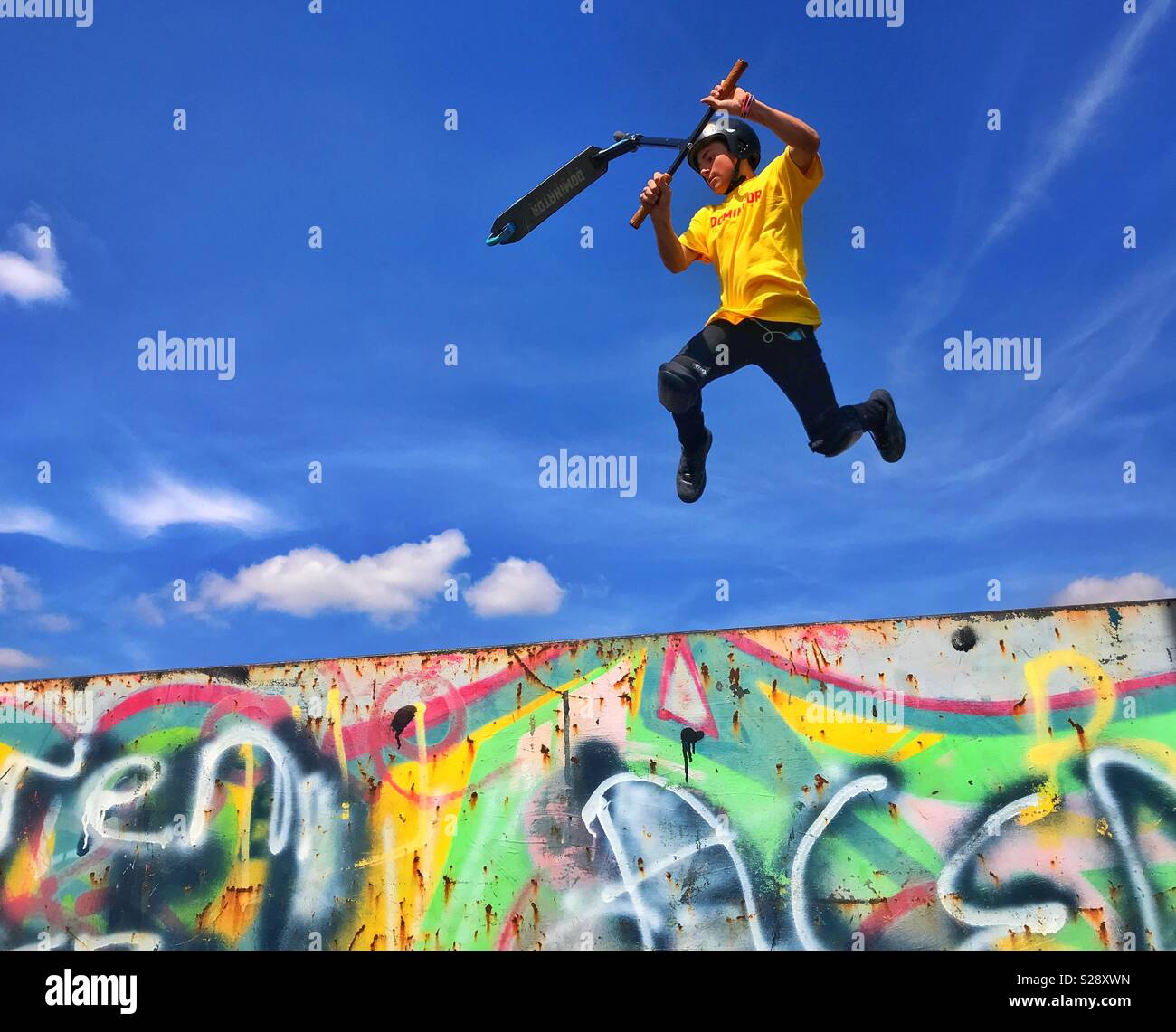 An impressive rotation stunt performed mid air by a boy using a scooter ...