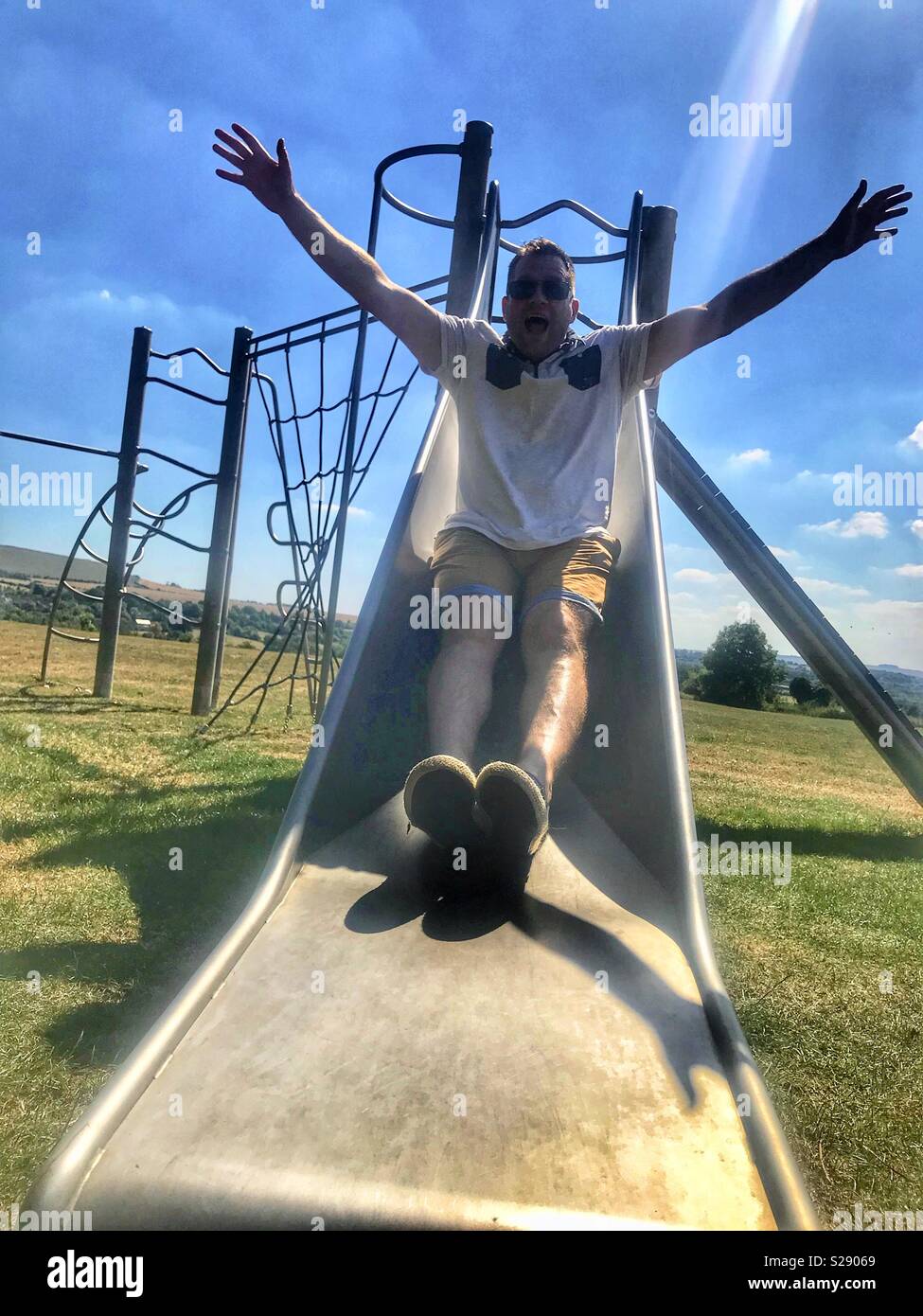 Kid sliding on slide hi-res stock photography and images - Alamy