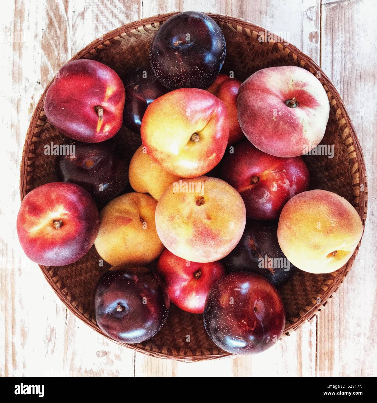 Basket of plums, peaches and nectarines Stock Photo - Alamy