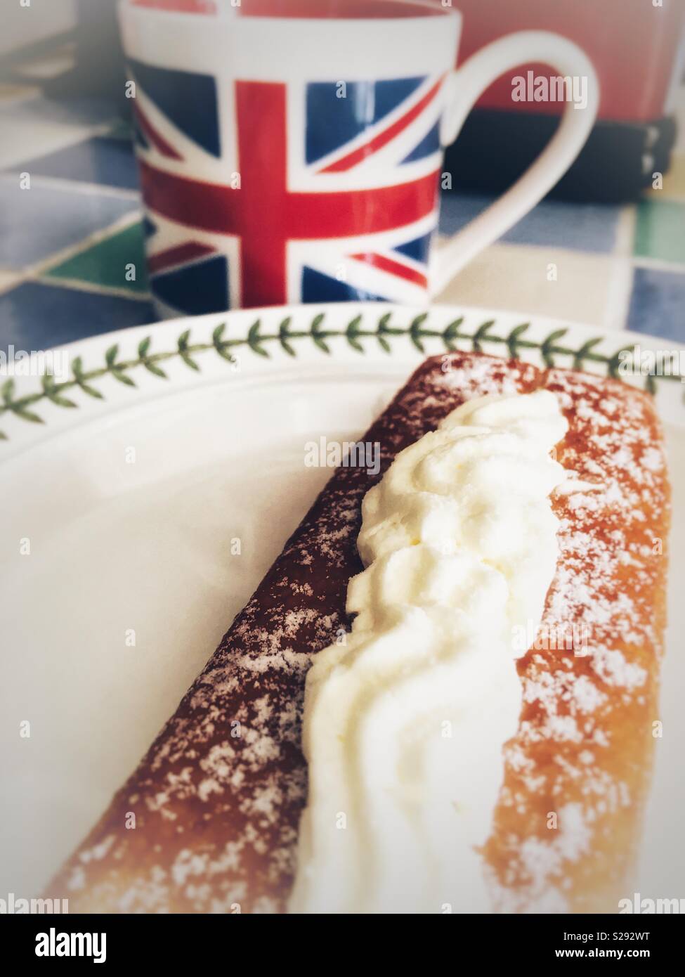 Cream doughnut and tea in an Union Jack decorated mug Stock Photo - Alamy