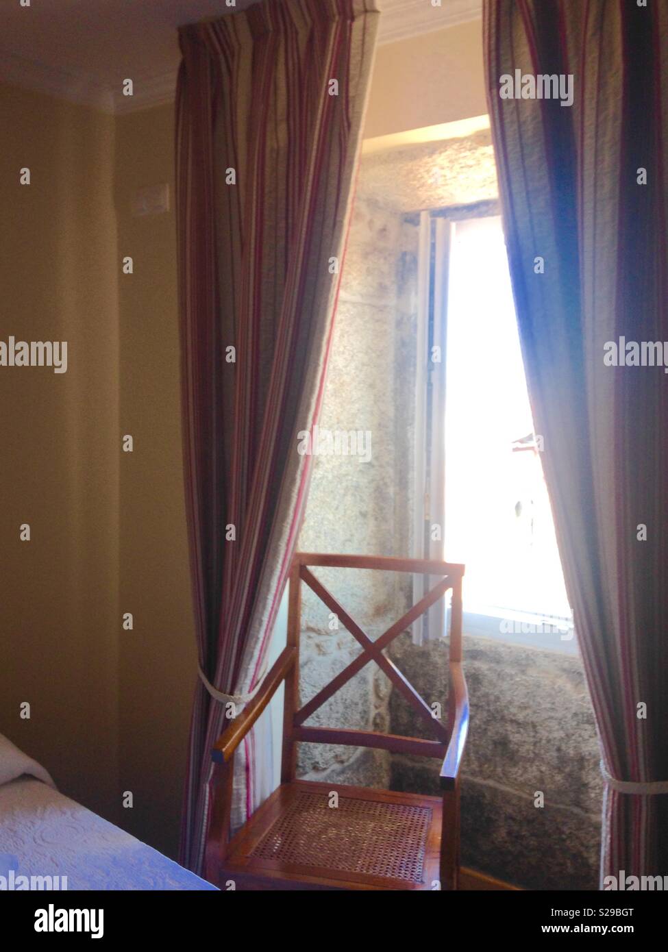 Hotel room with window and stone walls Stock Photo - Alamy
