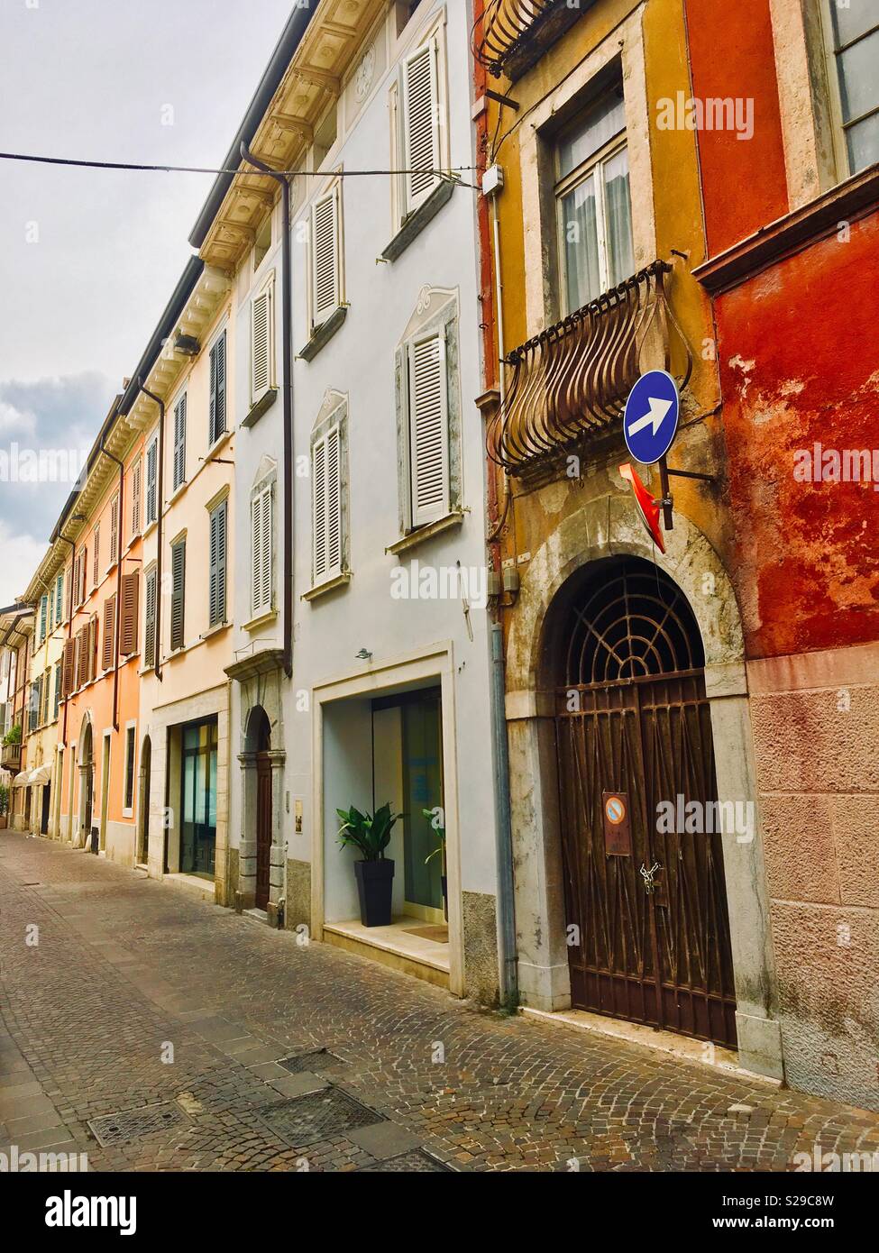 Italian back street with-doorways, shutters and coloured plaster Stock ...