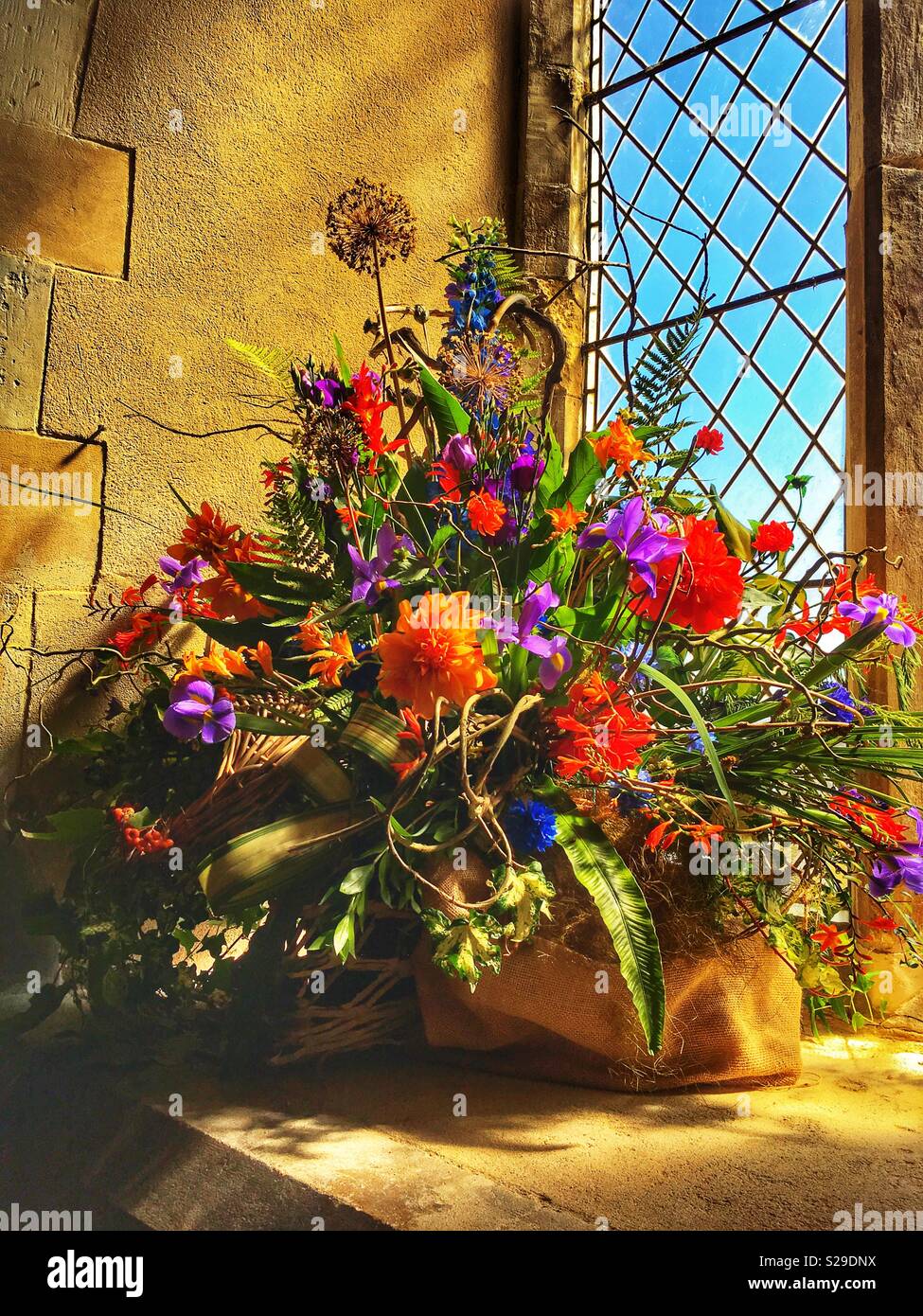 Fresh British garden flowers displayed in a church Stock Photo - Alamy