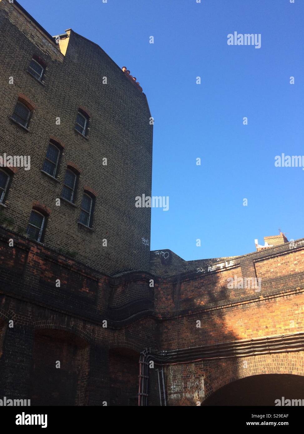 London brick building and bridge Stock Photo - Alamy