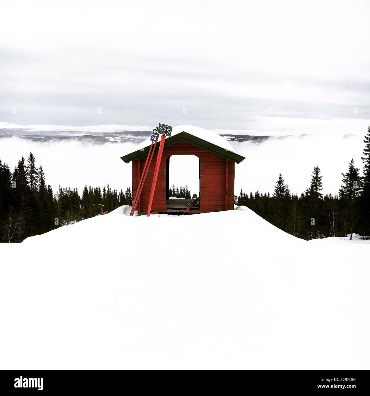 Tiny red snow cabin Stock Photo - Alamy