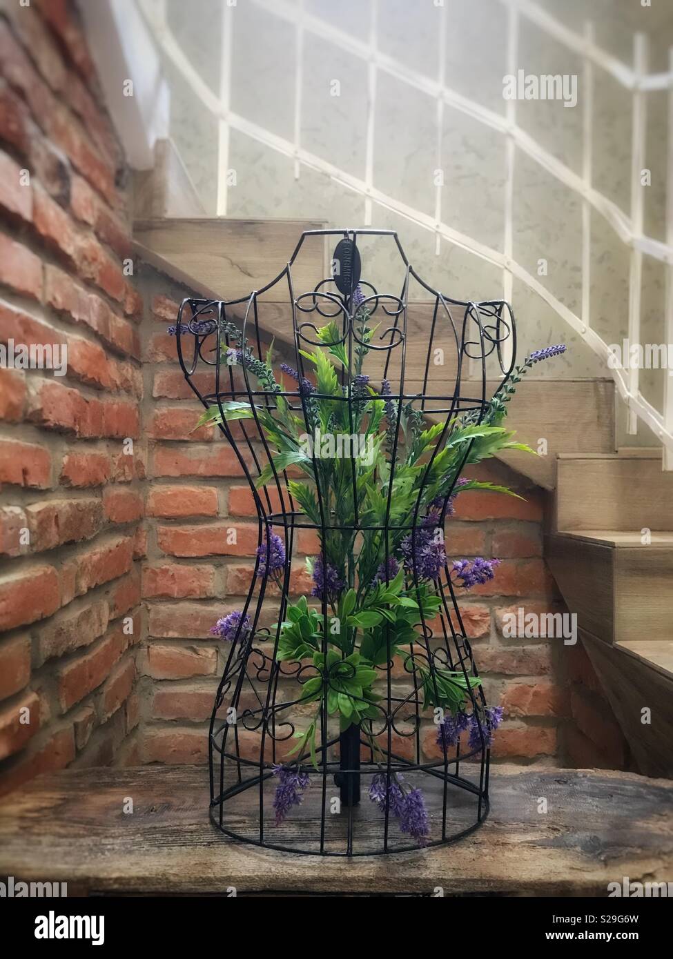 A floral display within the wire frame of a dressmaker’s torso on a ...