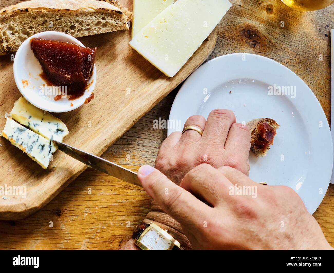 Cheese board with a man’s hands and a plate Stock Photo - Alamy