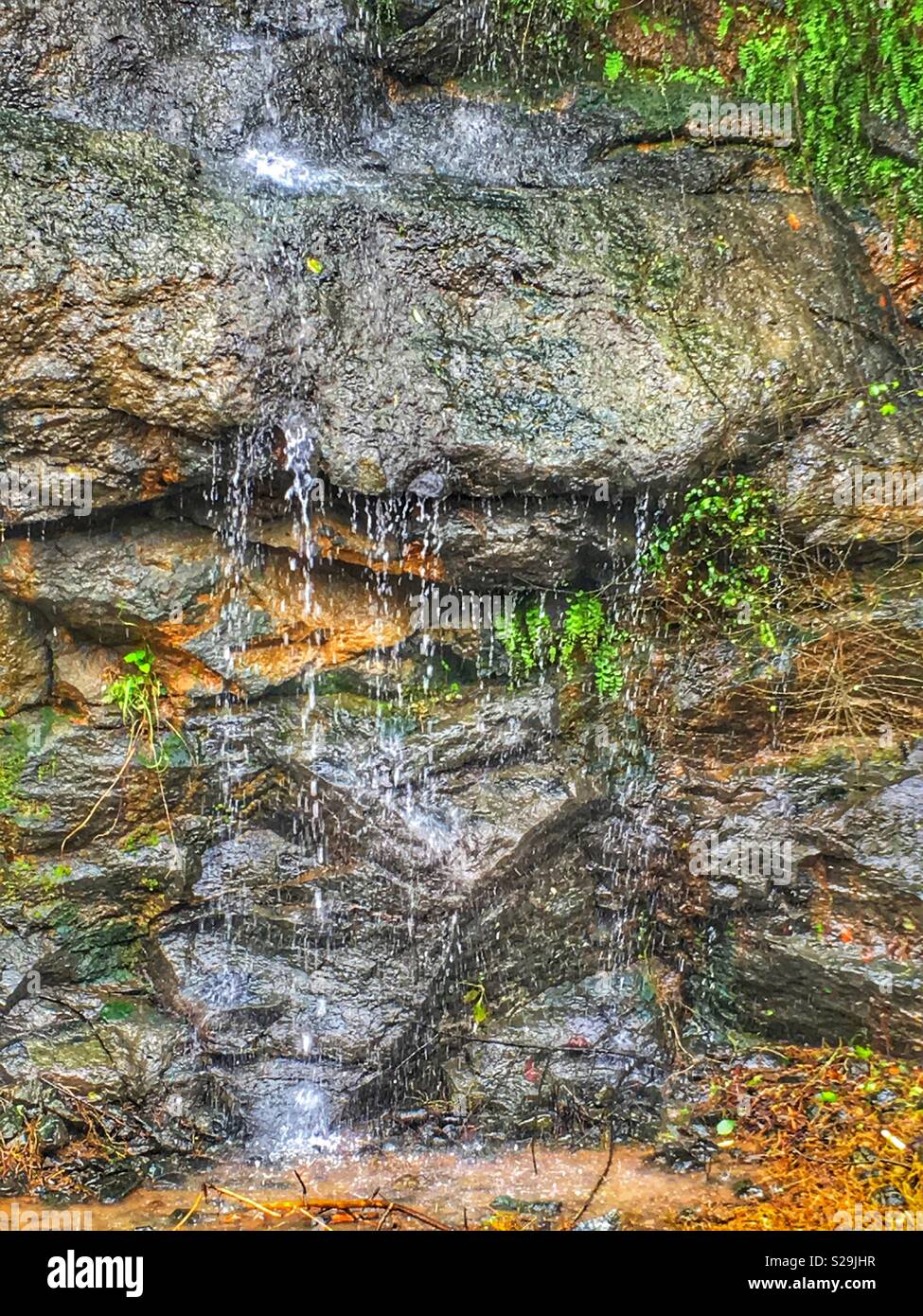 Rain water pouring against the stone wall Stock Photo - Alamy