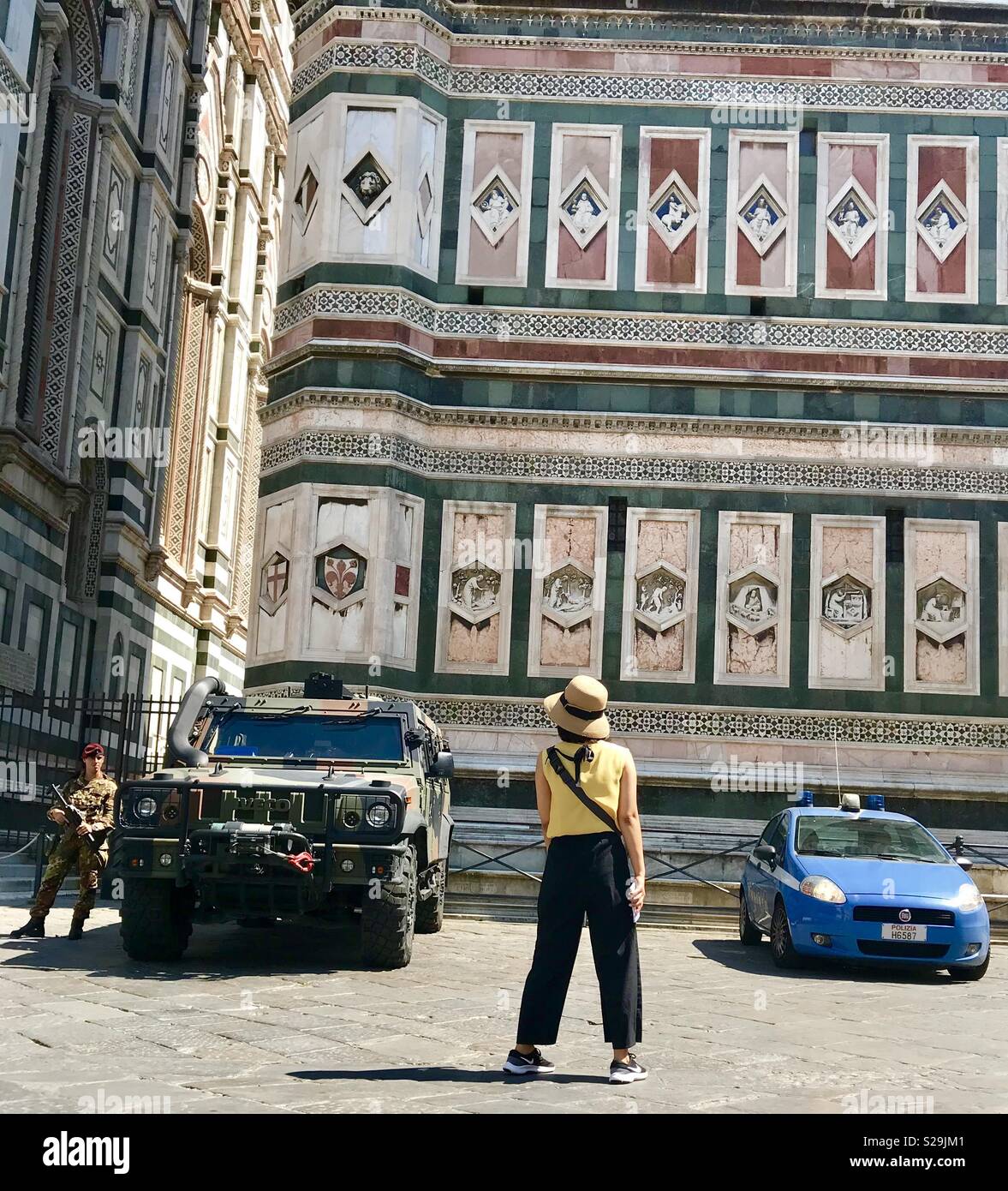 A Tourist In Piazza del Duomo Passes by the Italian Security Stock ...