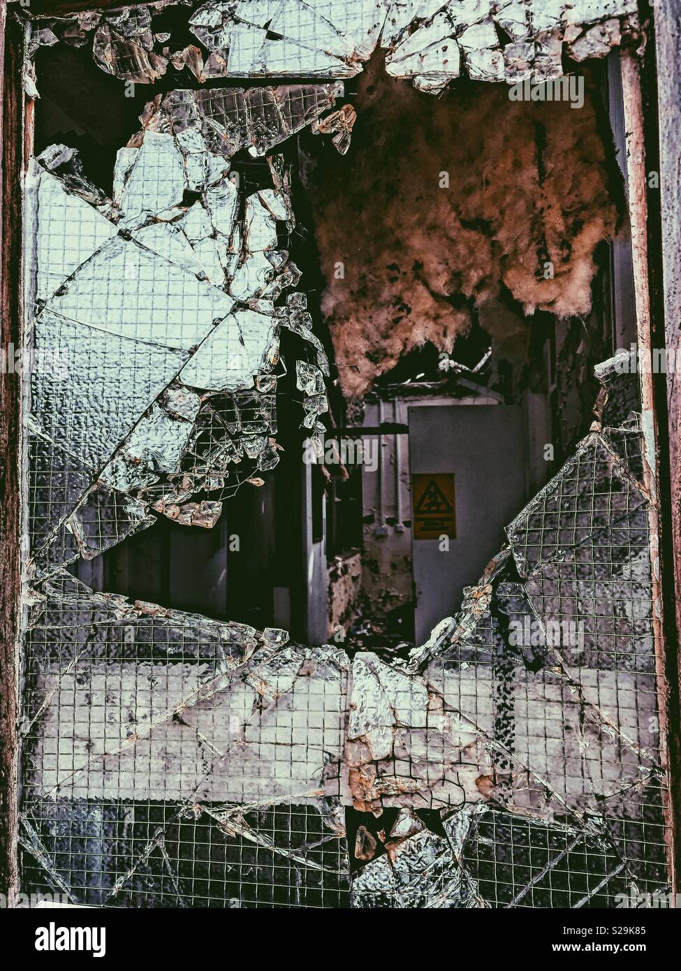 Smashed window at an abandoned hospital Stock Photo - Alamy