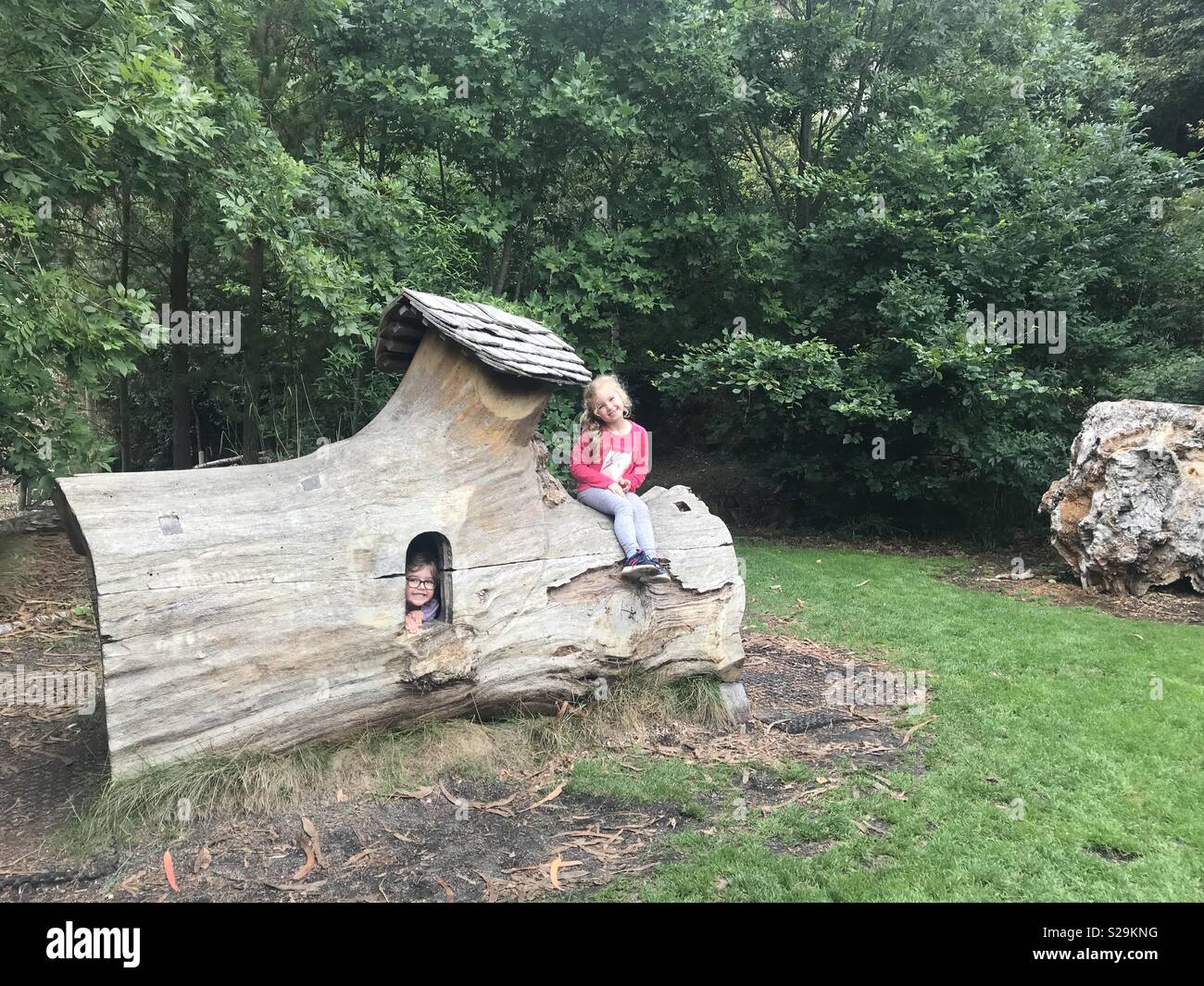 Girls playing in a log house Stock Photo - Alamy