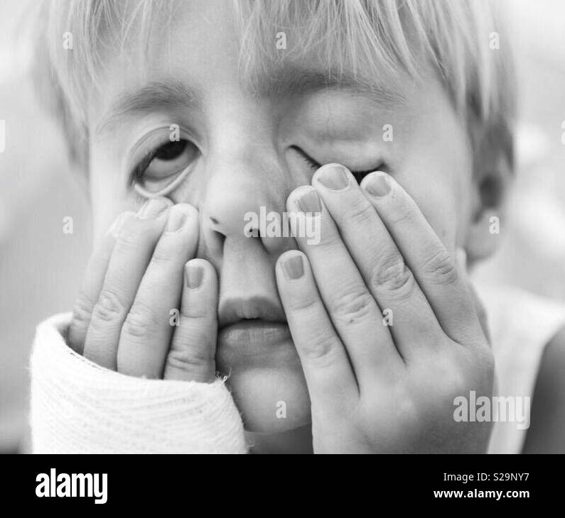 Young girl pulling faces and wincing Stock Photo - Alamy