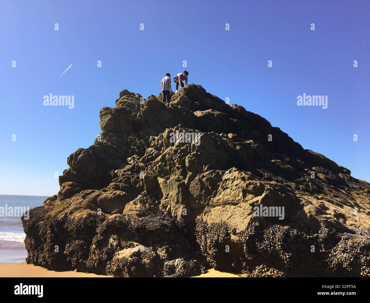 Rock Climbing with Little Brother Stock Photo - Alamy