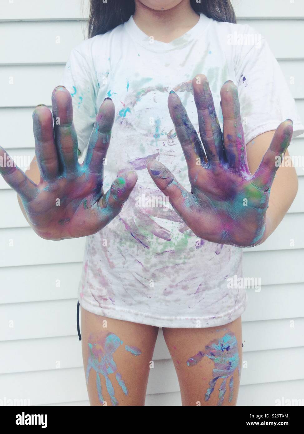 Young girl with messy painted hands Stock Photo - Alamy