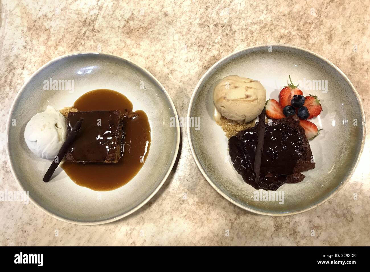 Chocolate brownie and sticky toffee pudding desert bowls together Stock ...