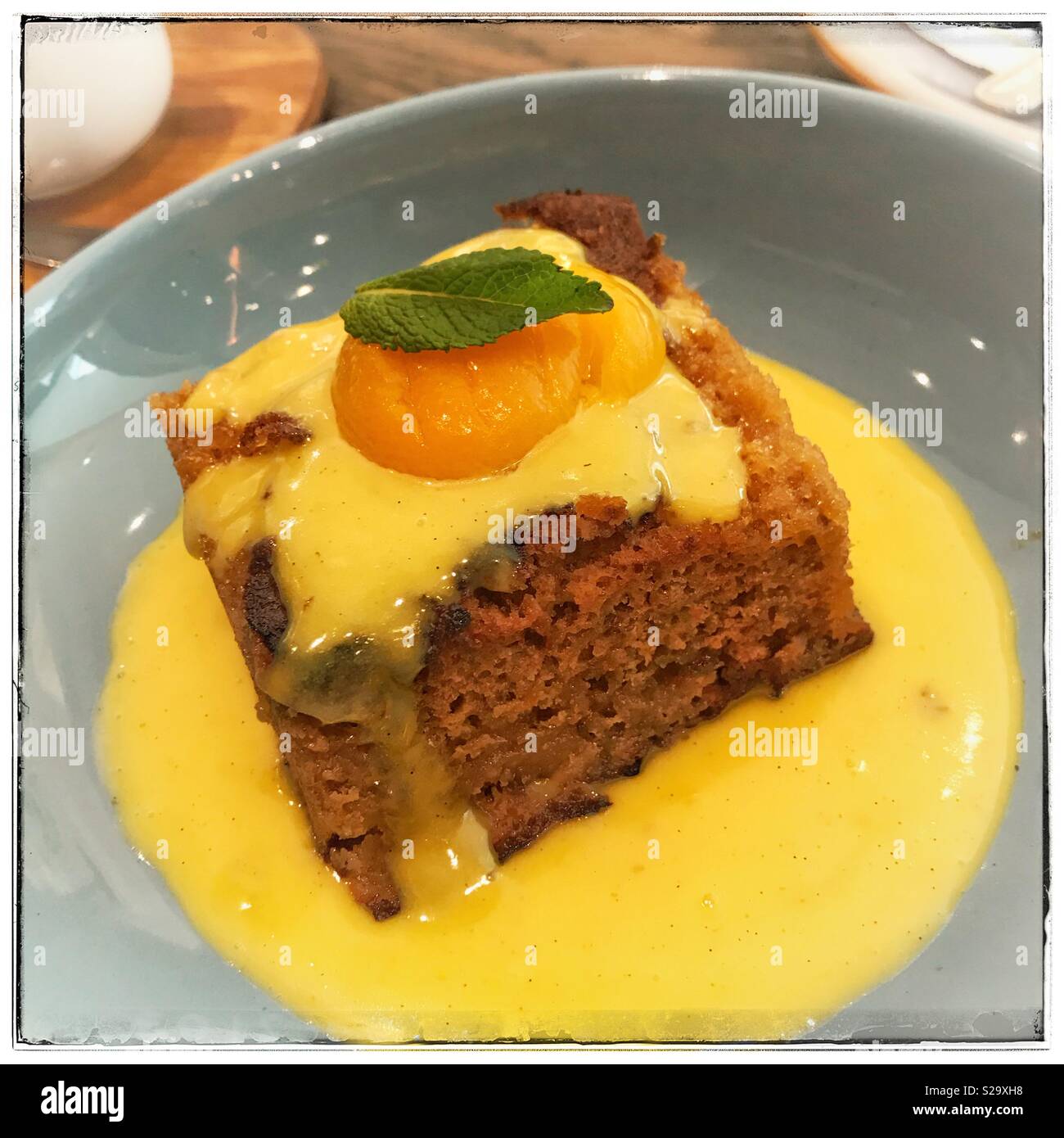 Malva pudding with custard Stock Photo - Alamy