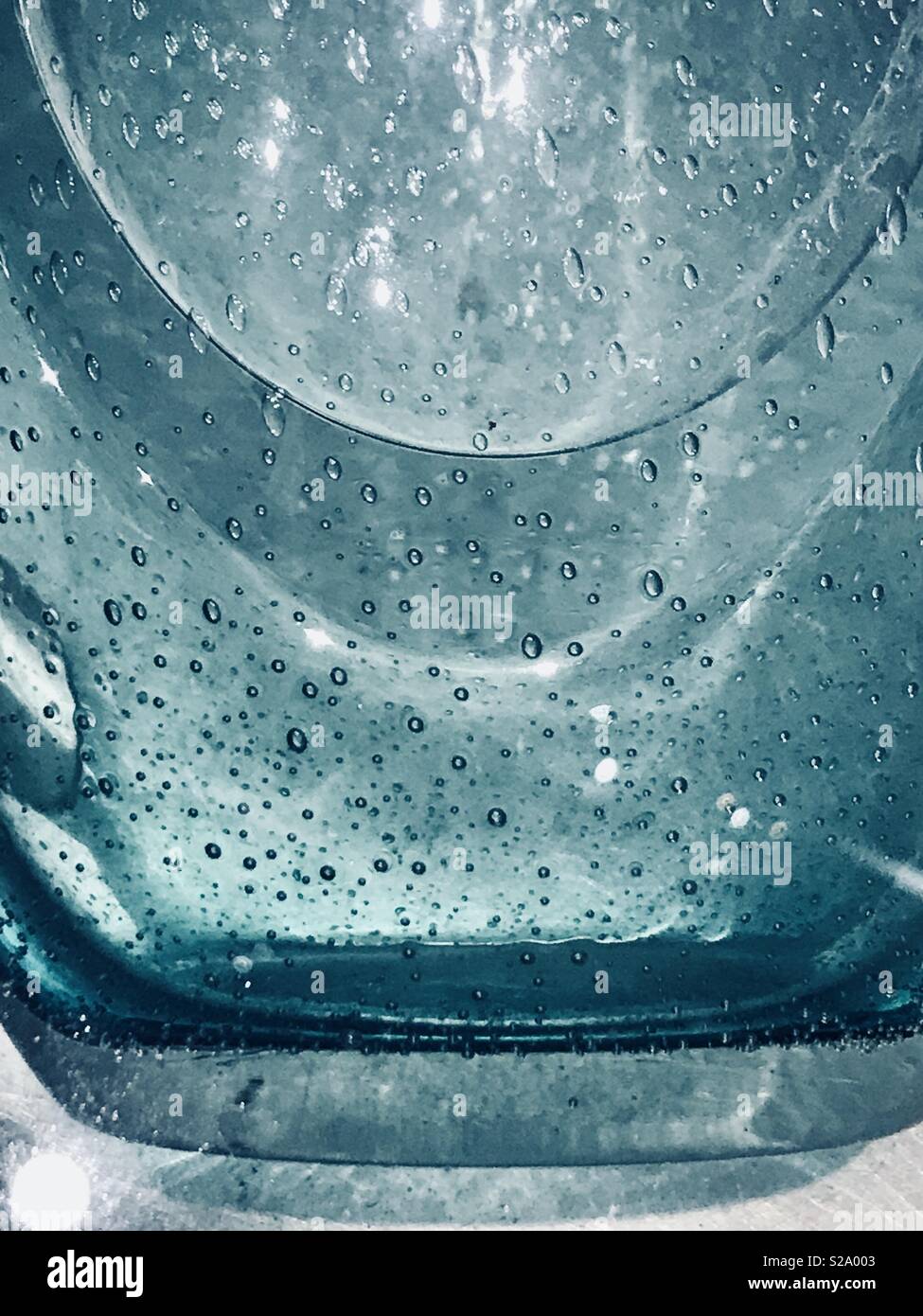 Water in a blue water jug submerged under water Stock Photo - Alamy