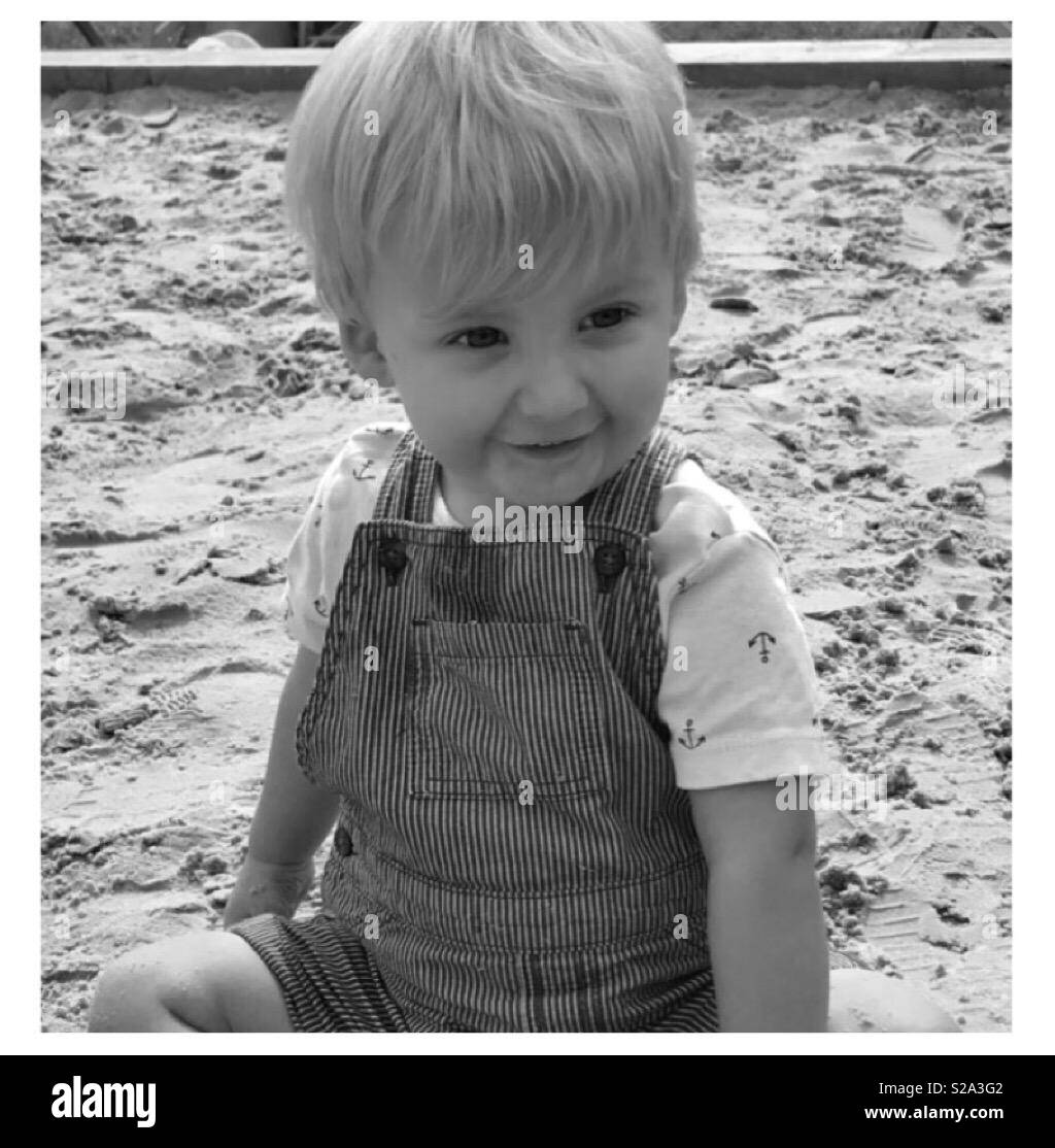 Boy in a sand pit Stock Photo - Alamy