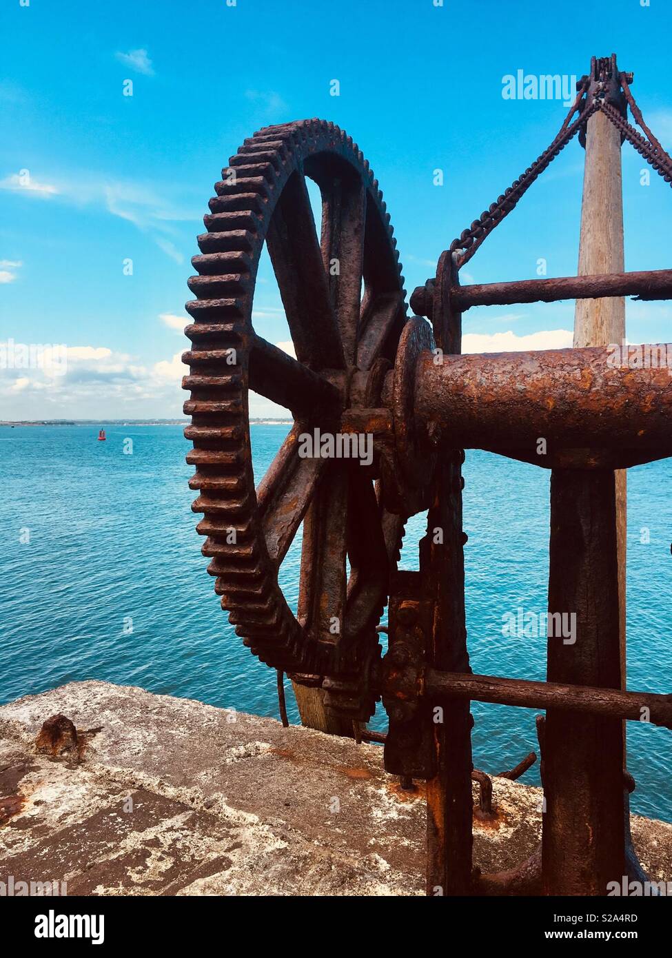 Rusty metal wheel at waterside Stock Photo - Alamy