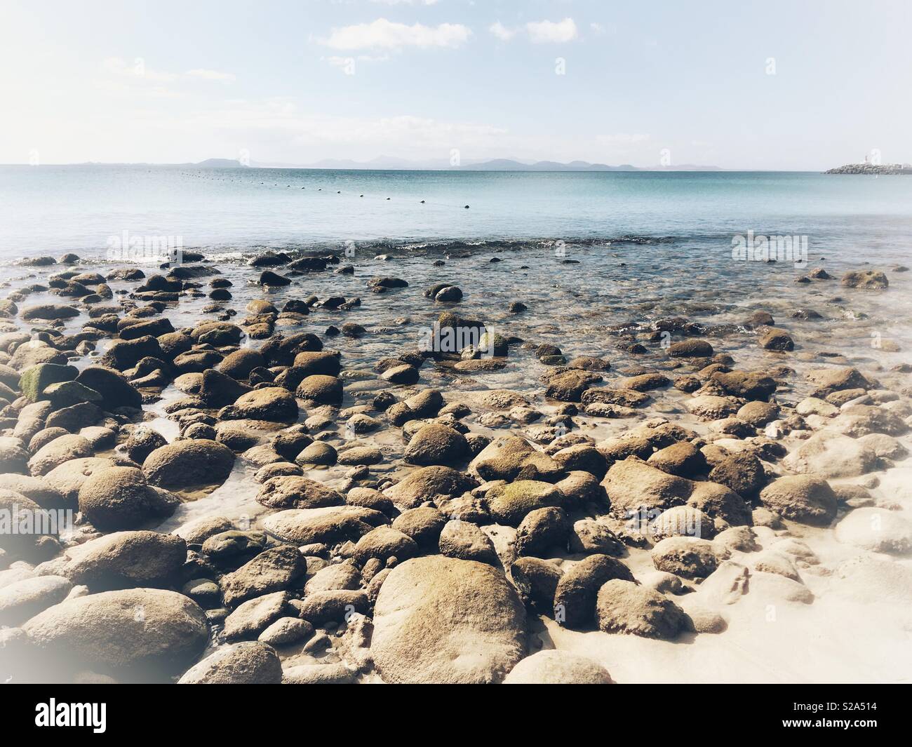 Beautiful beach with calm seas, sand and pebbles of different sizes ...