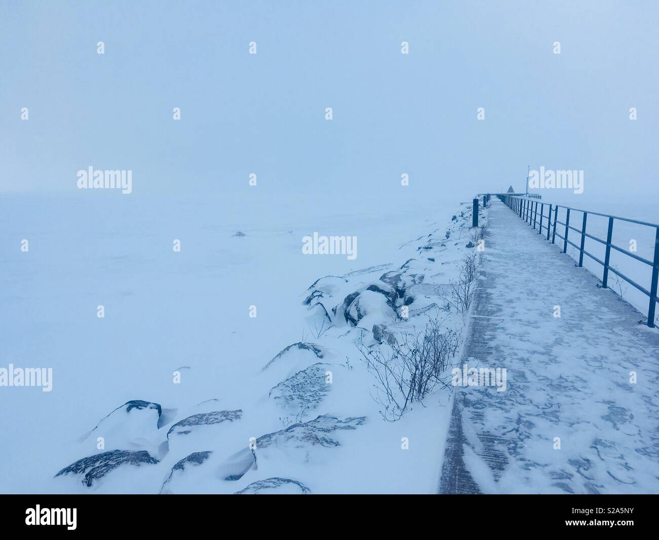 Snow covered pier Stock Photo - Alamy
