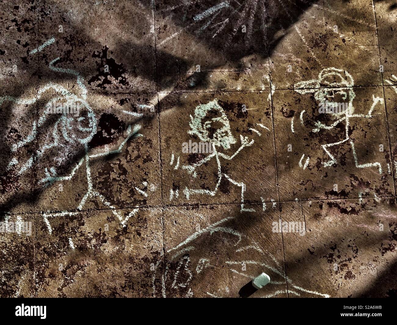 Dancing chalk stick figures on cement porch floor Stock Photo - Alamy