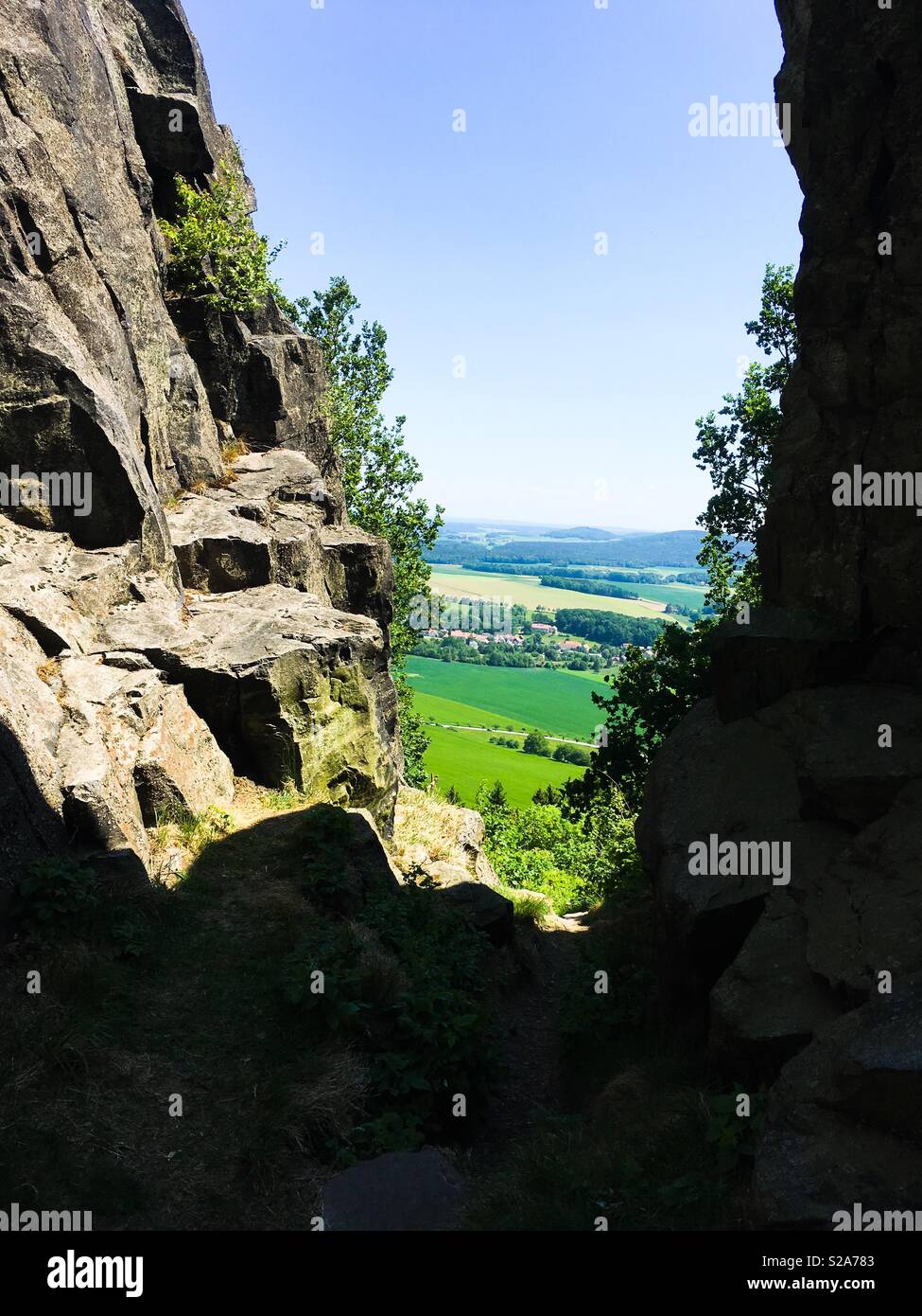 green landscape through rocks Stock Photo - Alamy