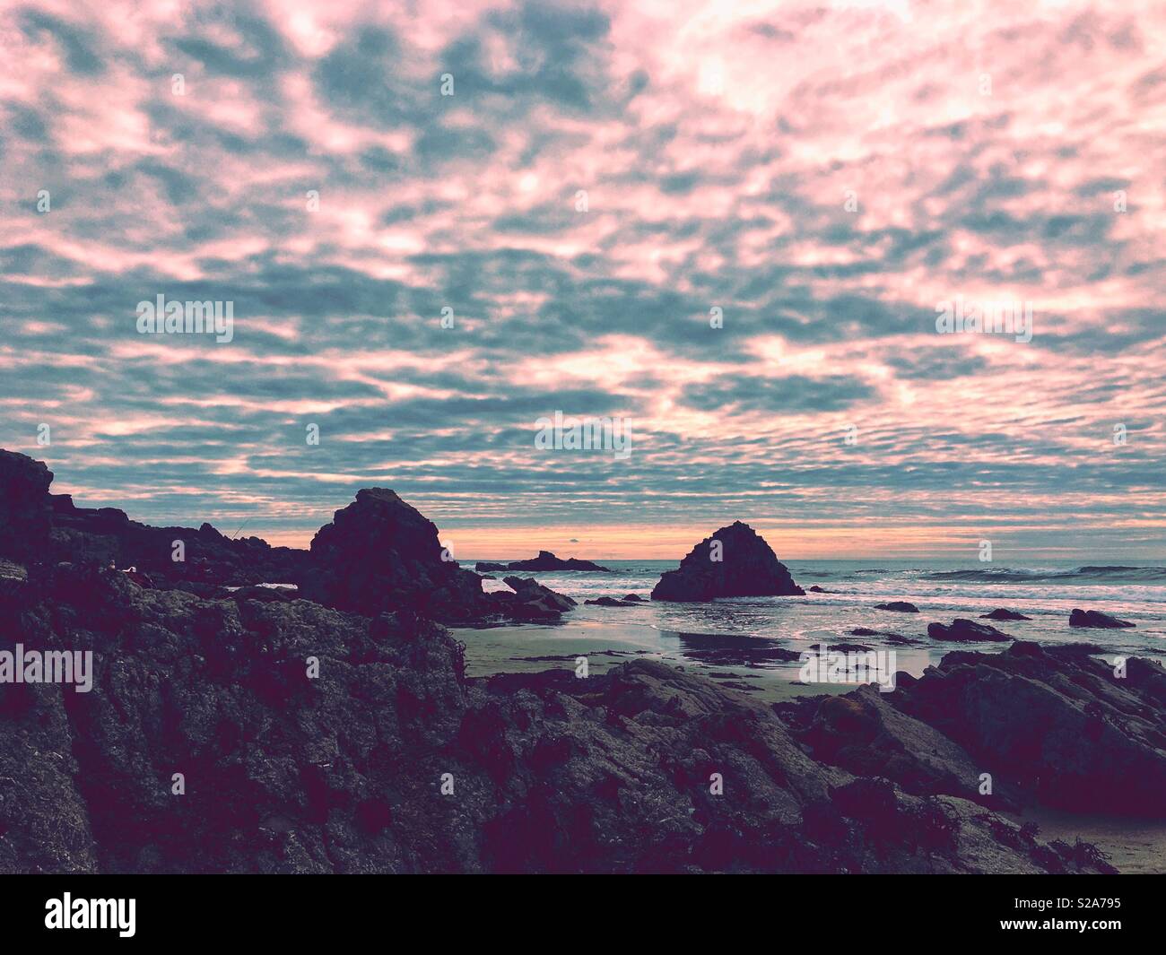 Sunset in Cornwall over a rugged rocky beach Stock Photo - Alamy