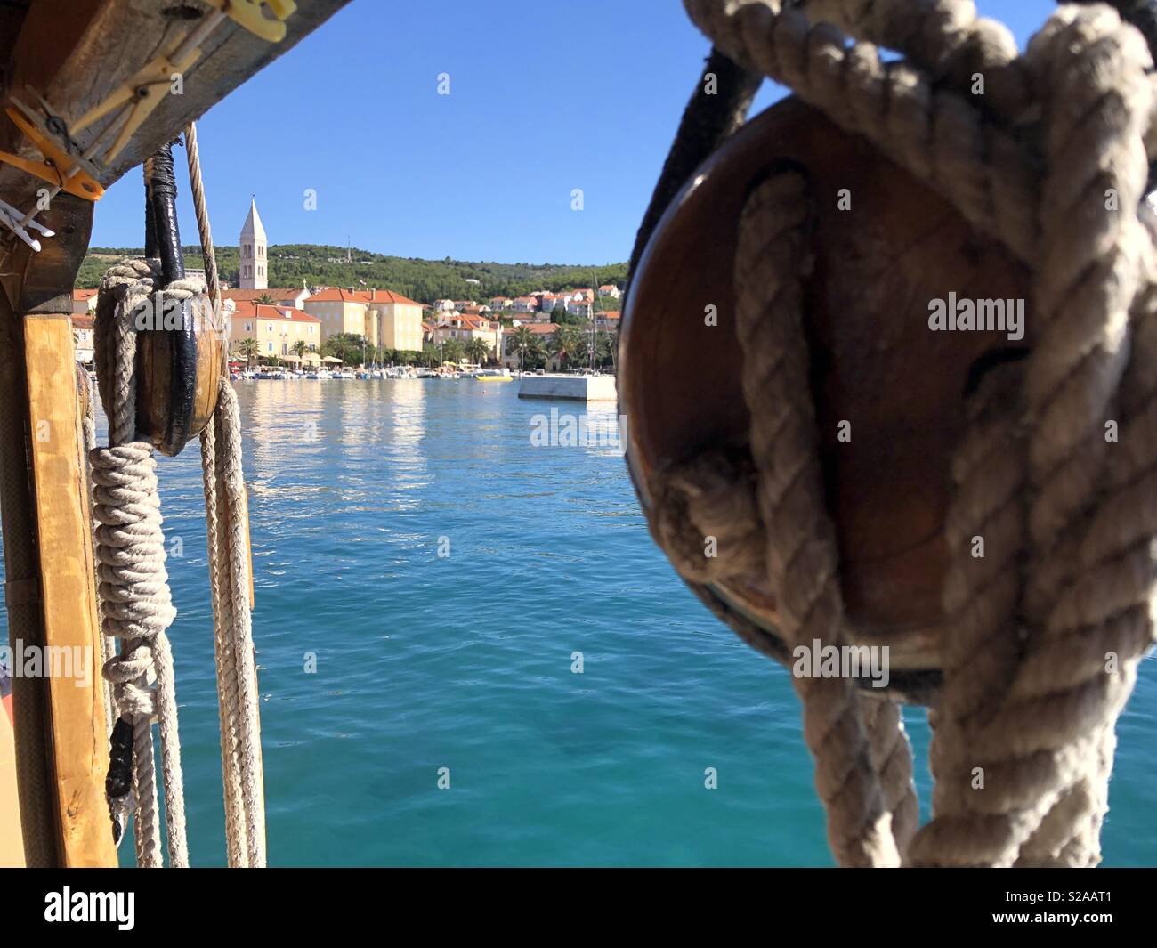 Sail ship entering port Stock Photo - Alamy
