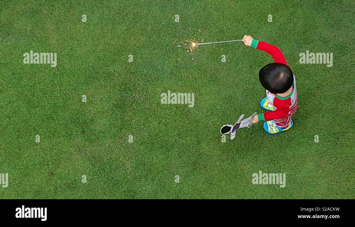 Child playing a firework Stock Photo - Alamy