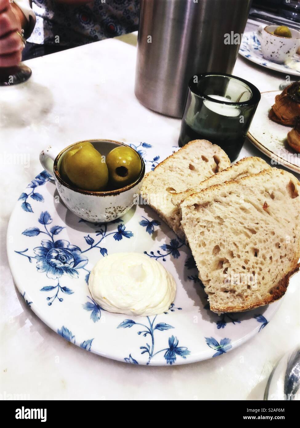 Olives, Sourdough Bread, Blue Patterned Crockery Stock Photo - Alamy